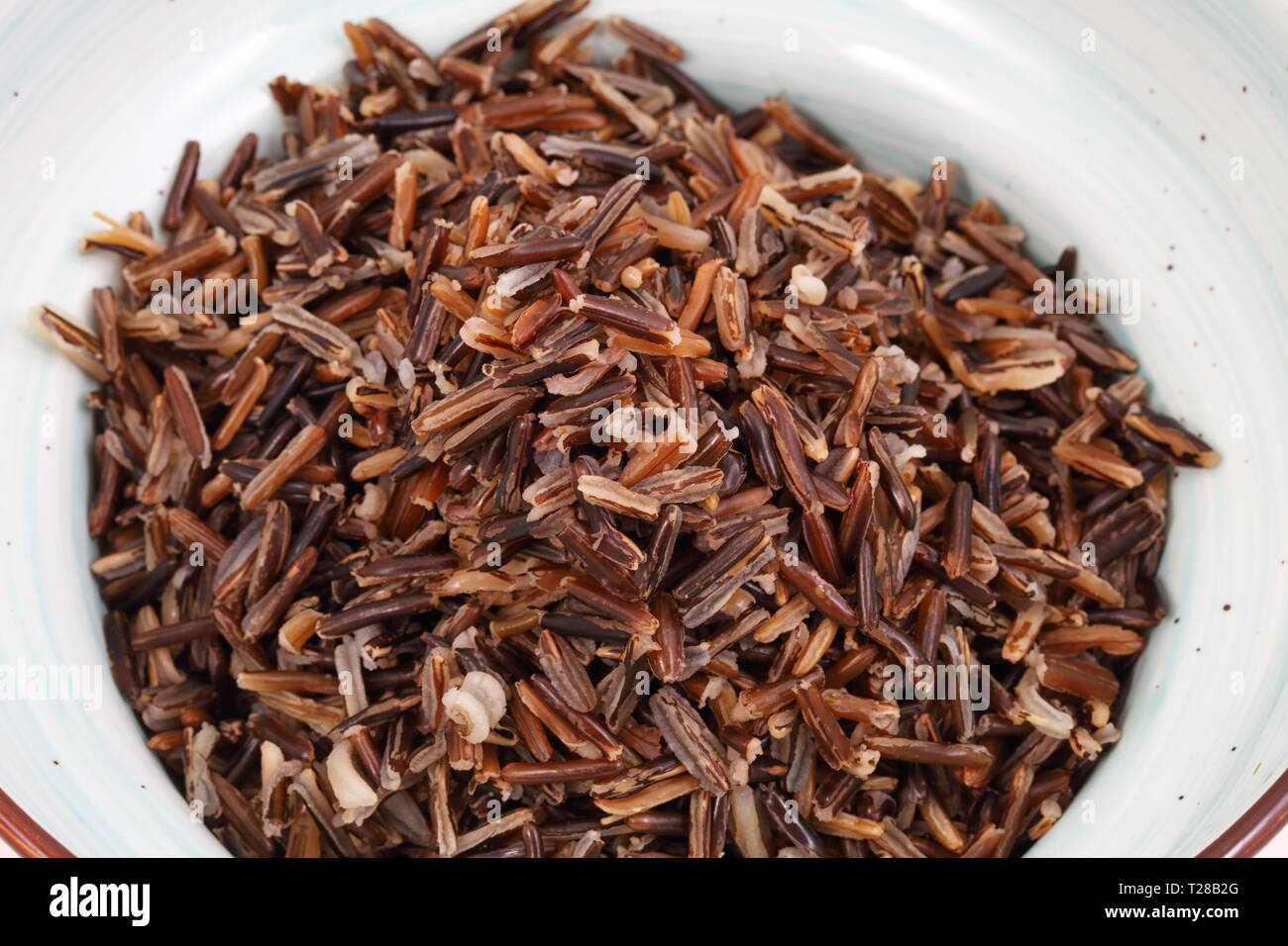 Dish of wild rice in a white plate close-up Stock Photo - Alamy