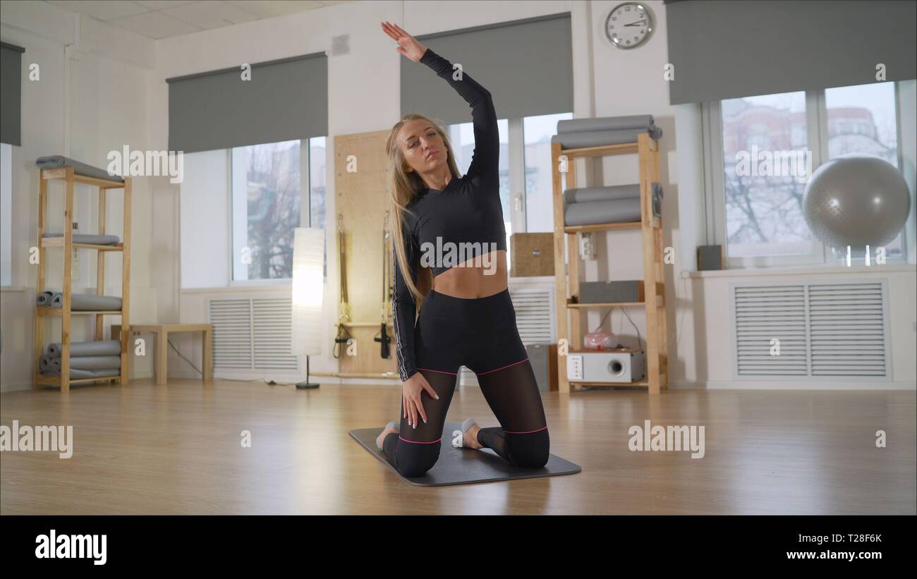 Woman doing exercises with fitball in fitness gym class. Engaging core ...