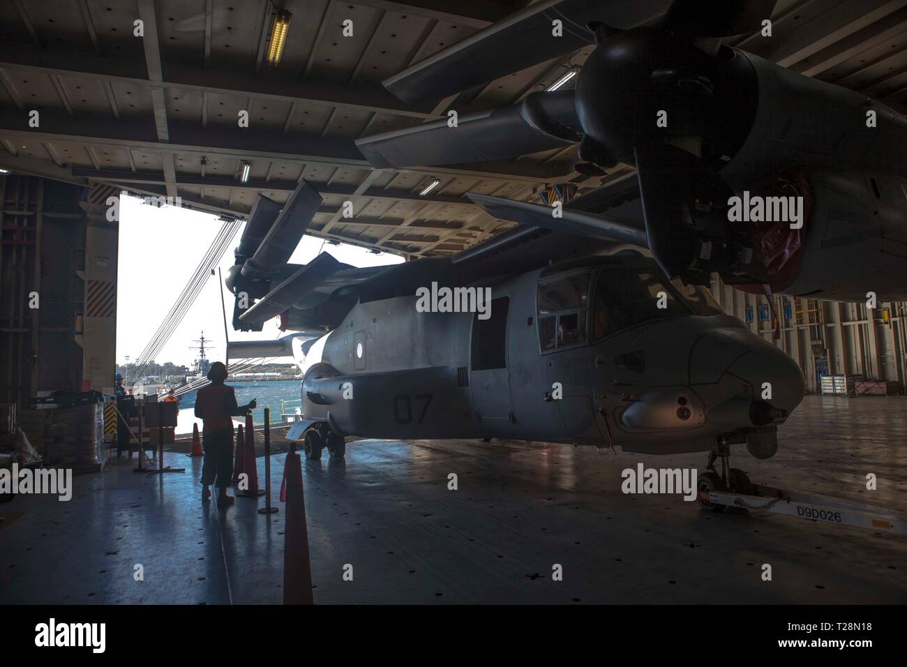 A U.S. Marine Corps MV-22B Osprey is unloaded from the MV Green Ridge ...