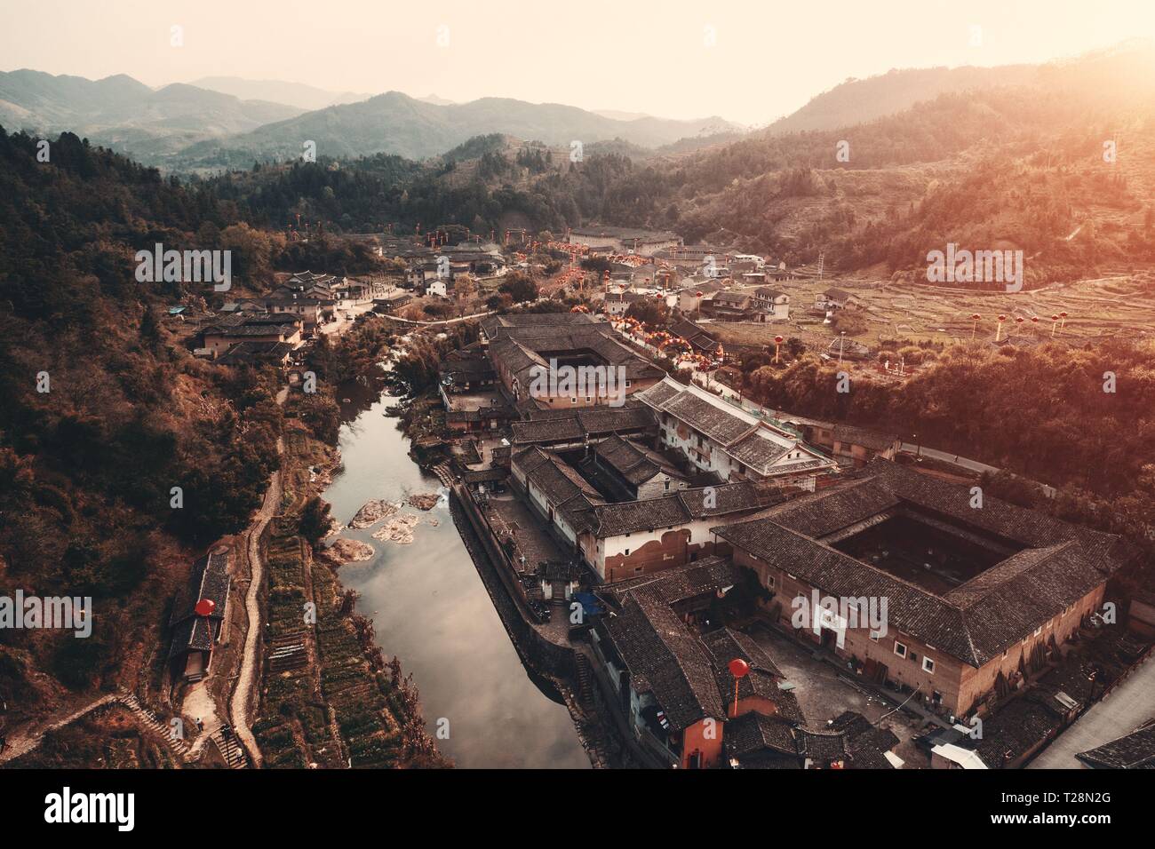 Aerial view of Tulou at sunset, the unique dwellings of Hakka in Fujian ...
