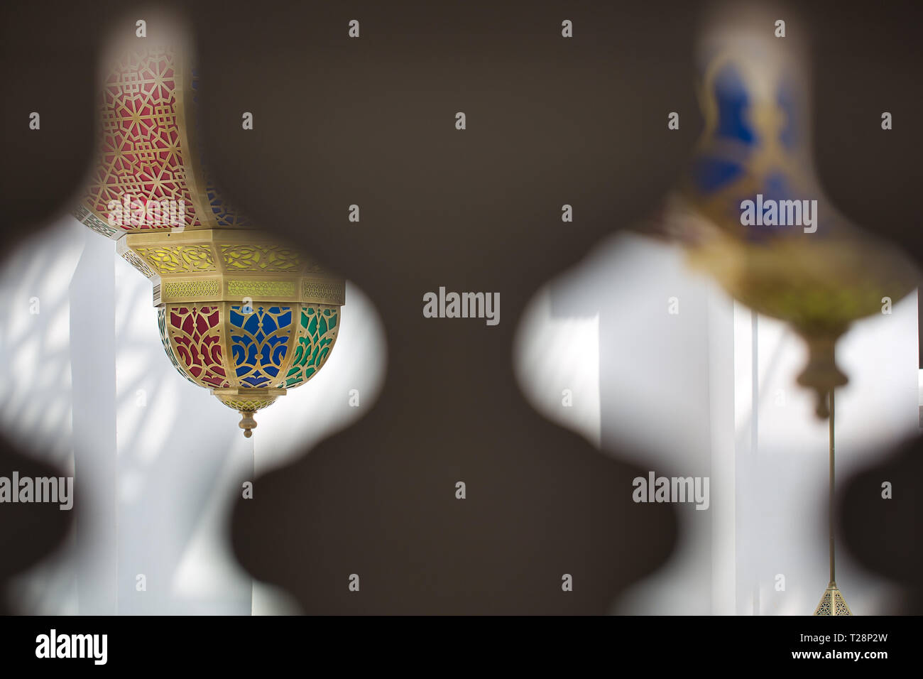 Peeking in a hole of terrace, looking at the Arabian design chandelier ...