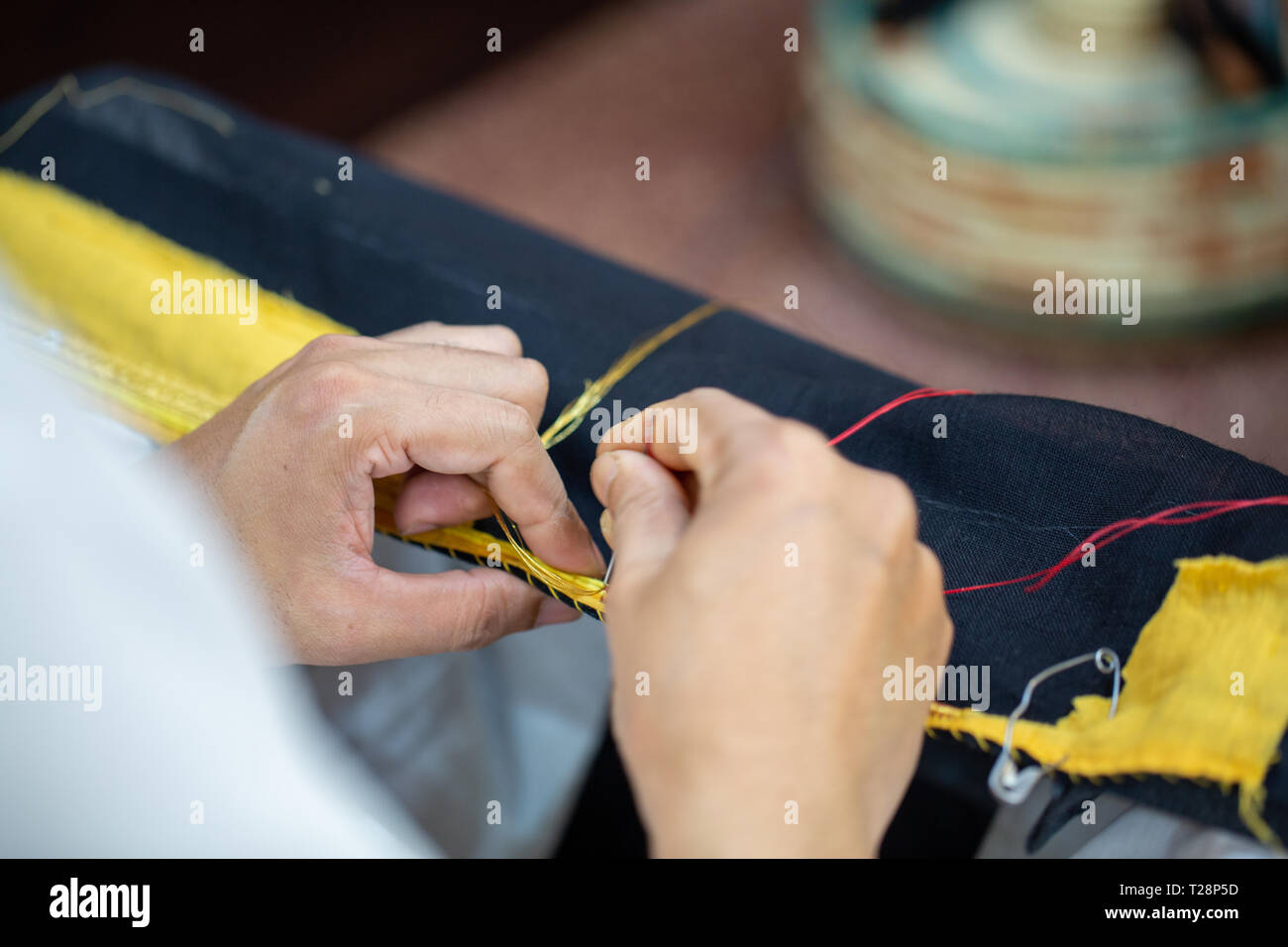 Detail shot of how the tailor are making a bisht, an Arabic cloak for ...