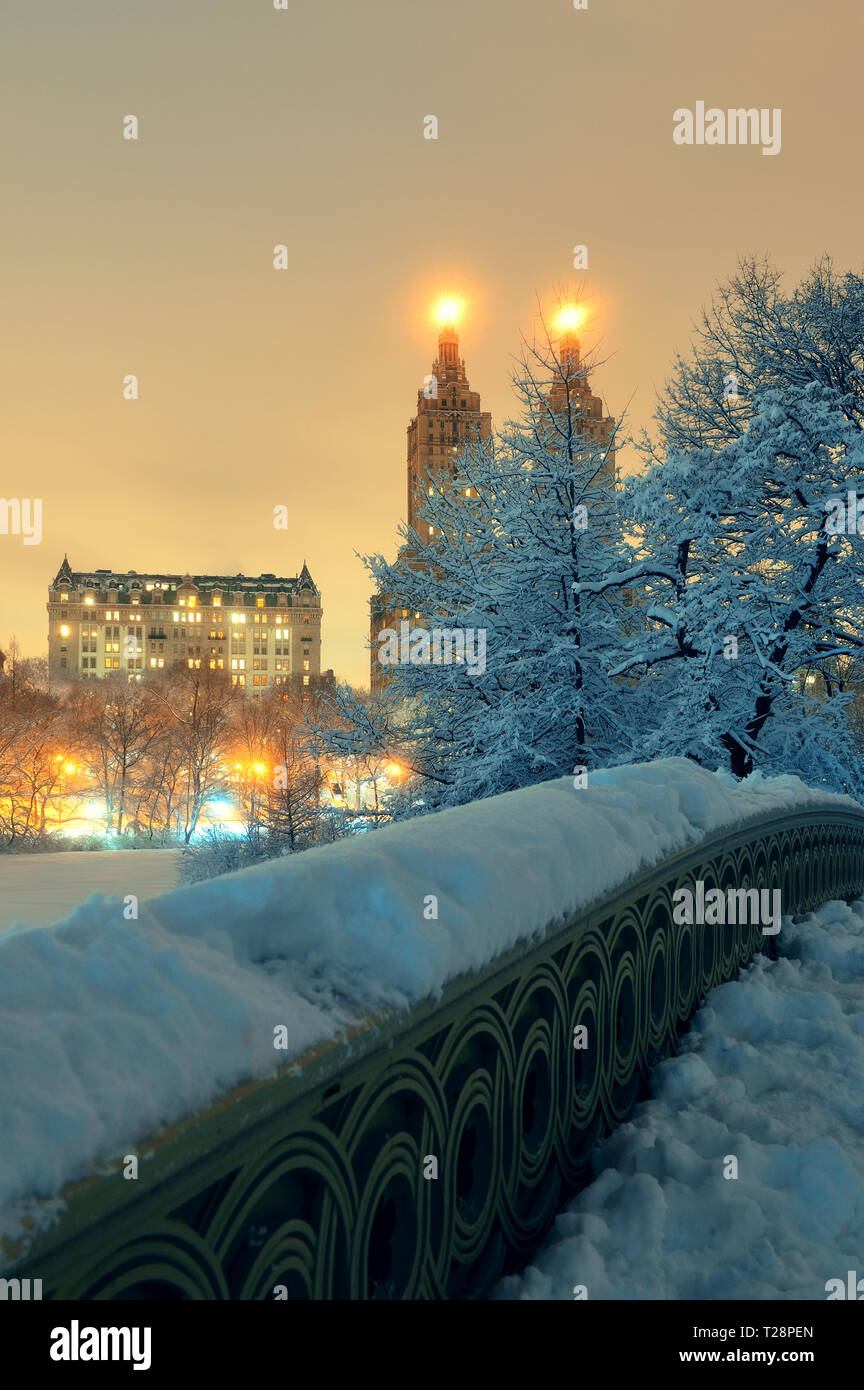 Central Park winter with skyscrapers and Bow Bridge in midtown ...