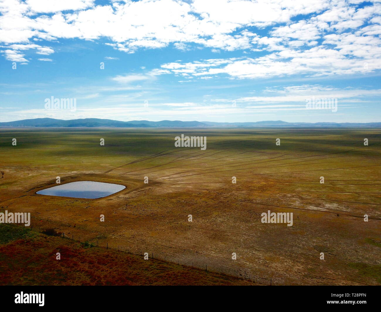 Empty Lake George nestled between a rural wind farm and farmland in ...