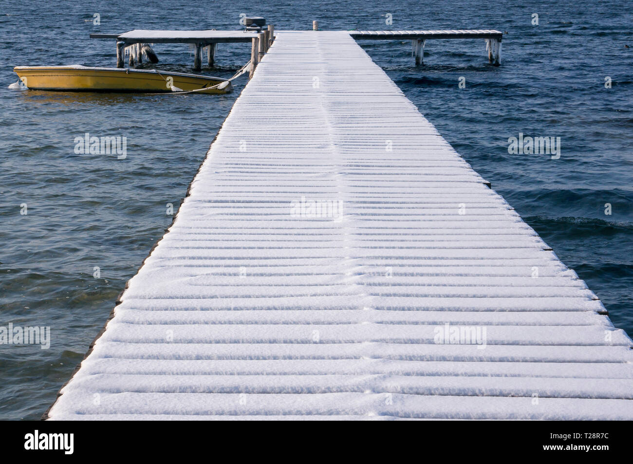 Snow covered boat dock and boat Stock Photo - Alamy