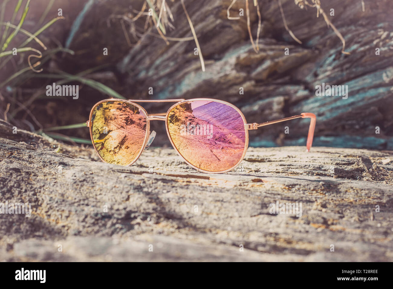 Sunglasses at the beach with sea reflection. Holidays, travel, vacation ...