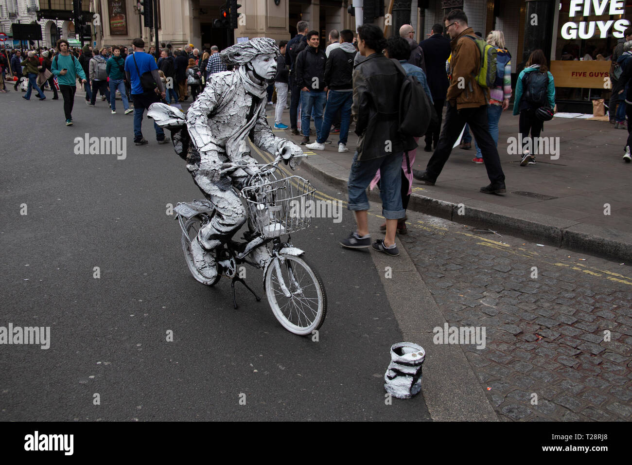 Statue busker in London. Riding a bike Stock Photo - Alamy