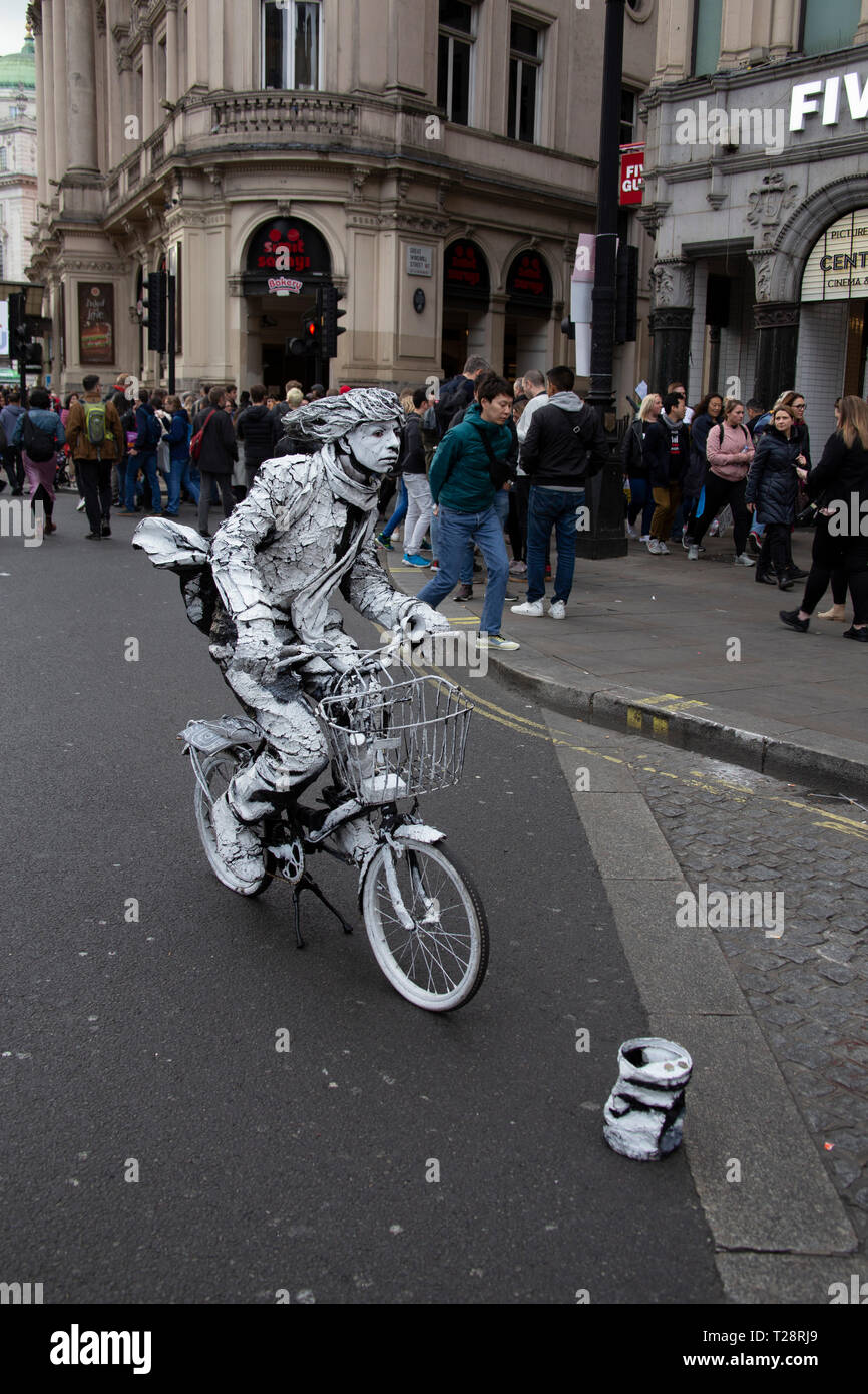 Statue busker in London. Riding a bike Stock Photo - Alamy