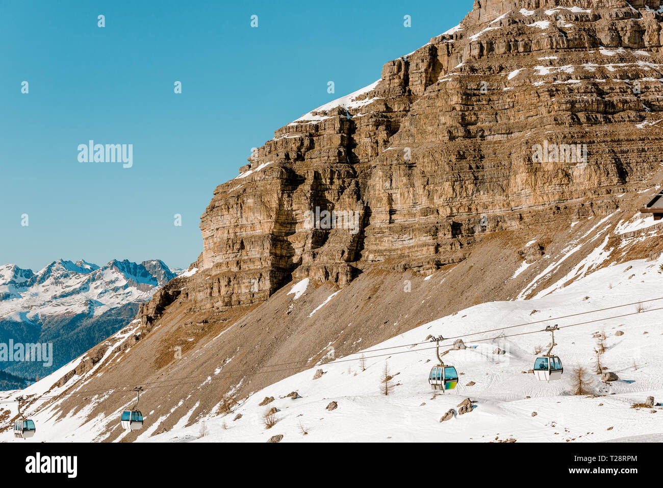 Cable car in the ski resort. Massive rock and mountains on the horizon ...