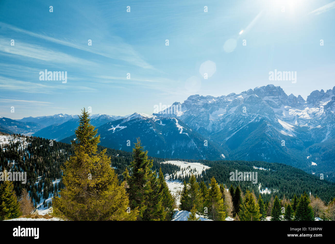 Beautiful winter Alpine landscape. Bright sun, snow-capped peaks and ...