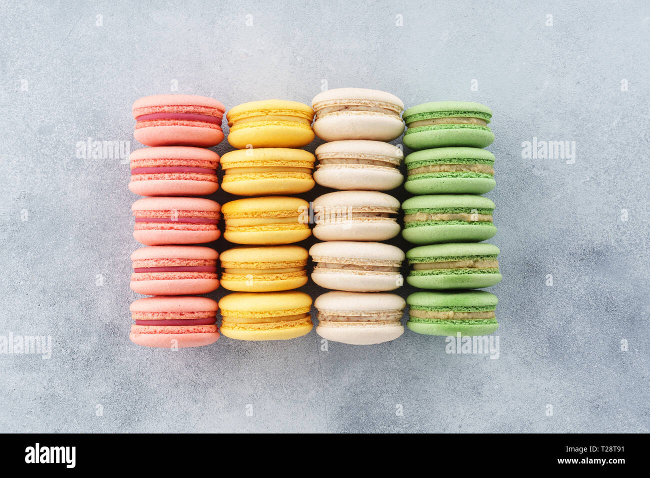 Colorful french macarons on a gray background. Top view. Space for text ...