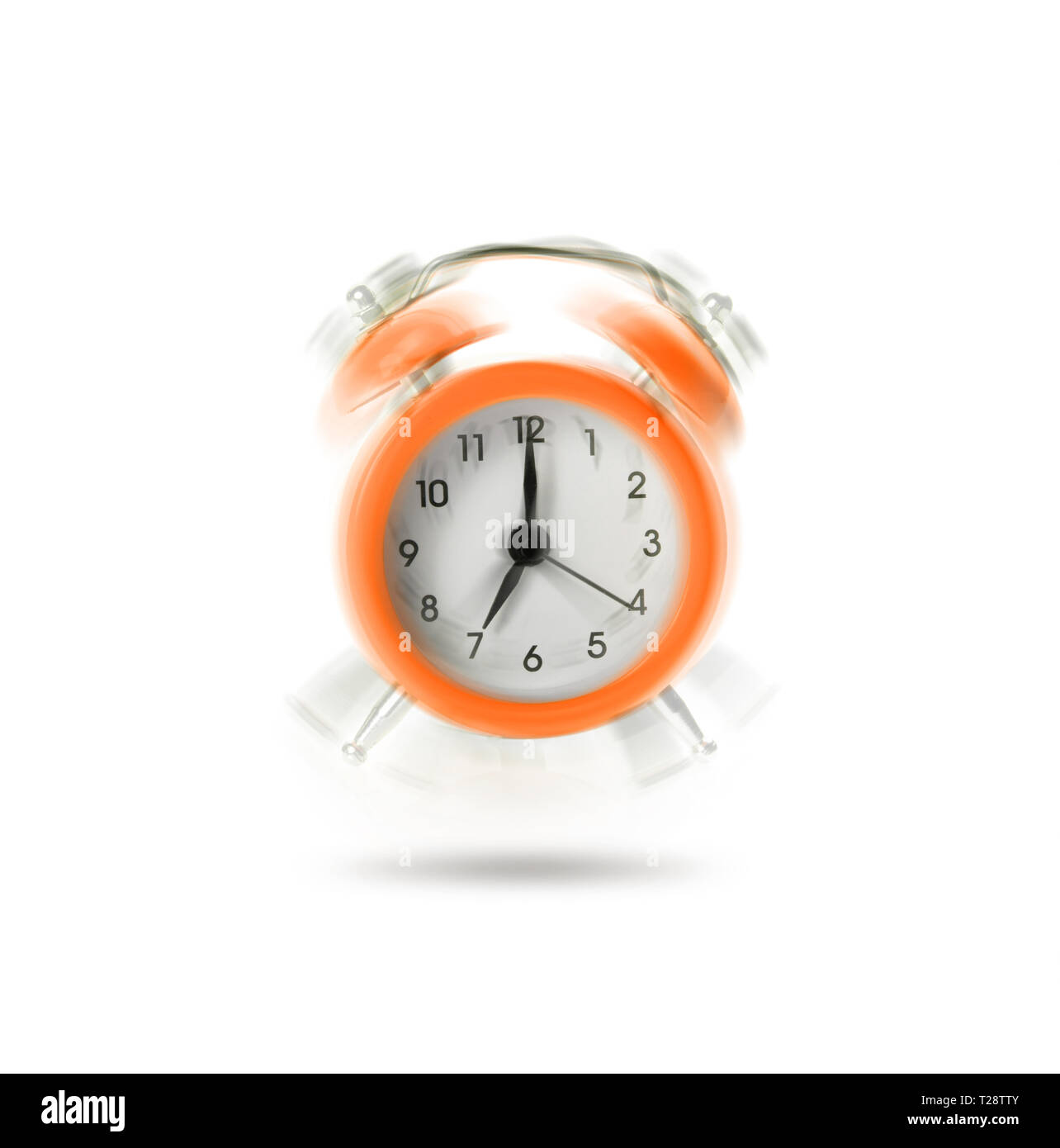 Orange ringing alarm clock isolated on white background. Motion blur ...