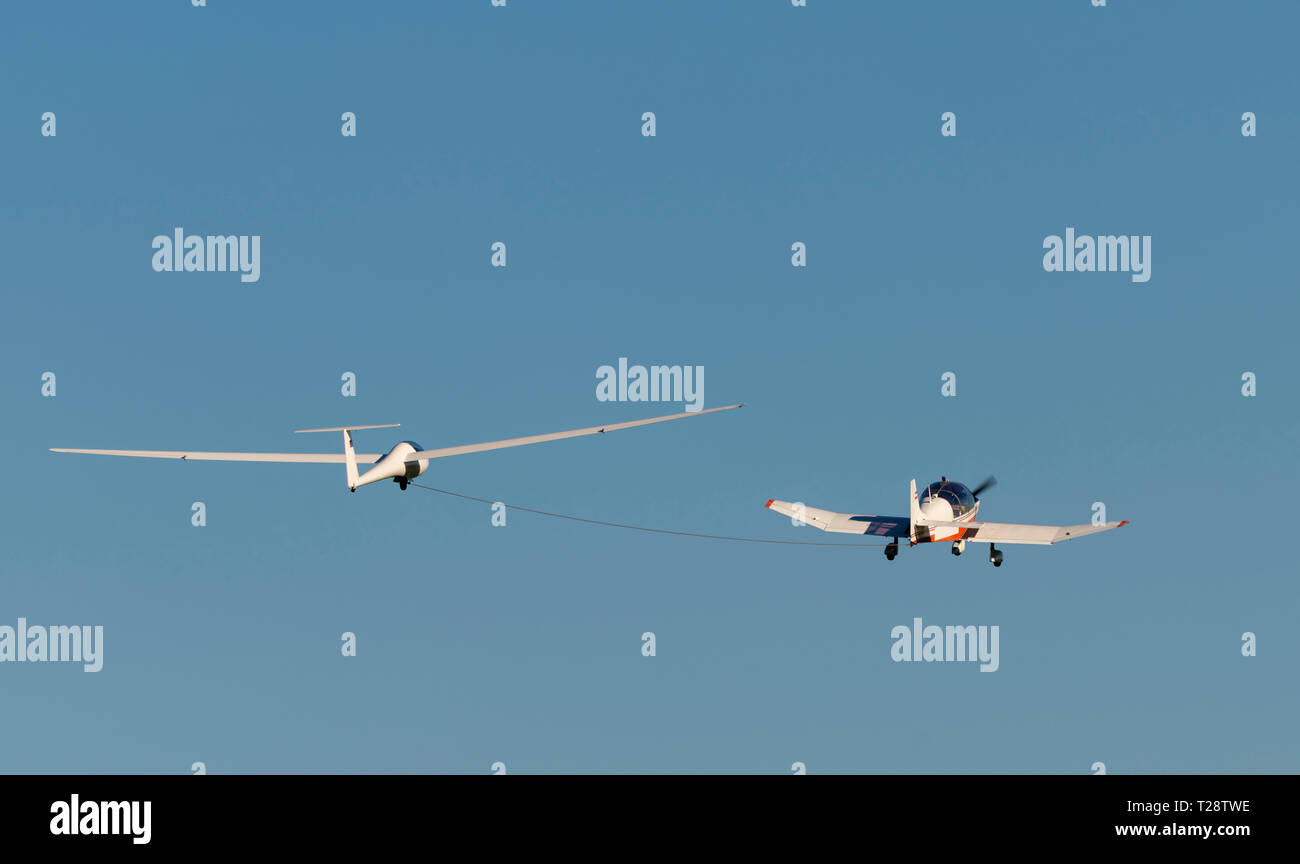 White modern glider which is increased by a small motorized sport ...