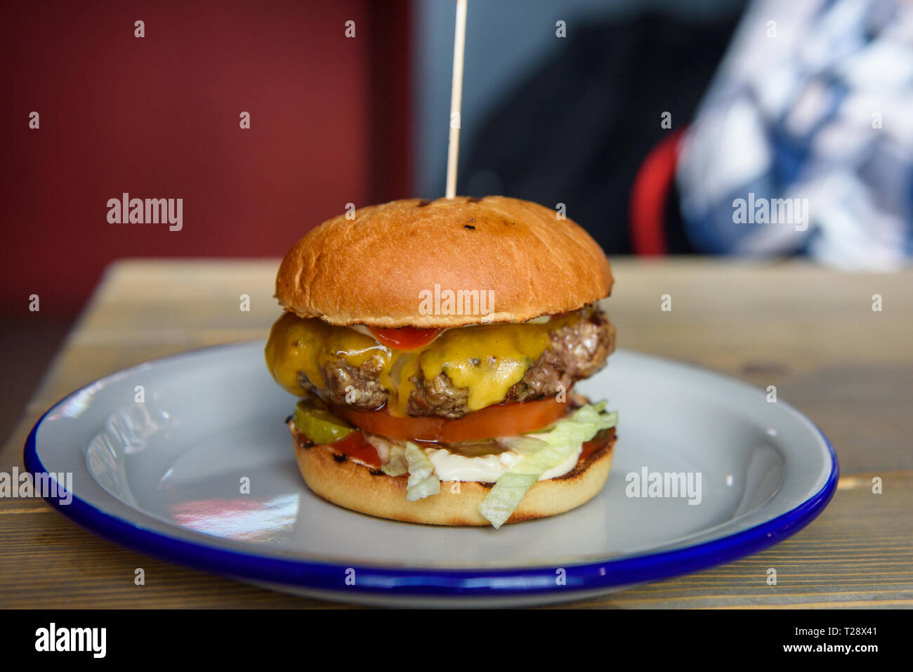 Beef burger on white plate ready to eat Stock Photo - Alamy