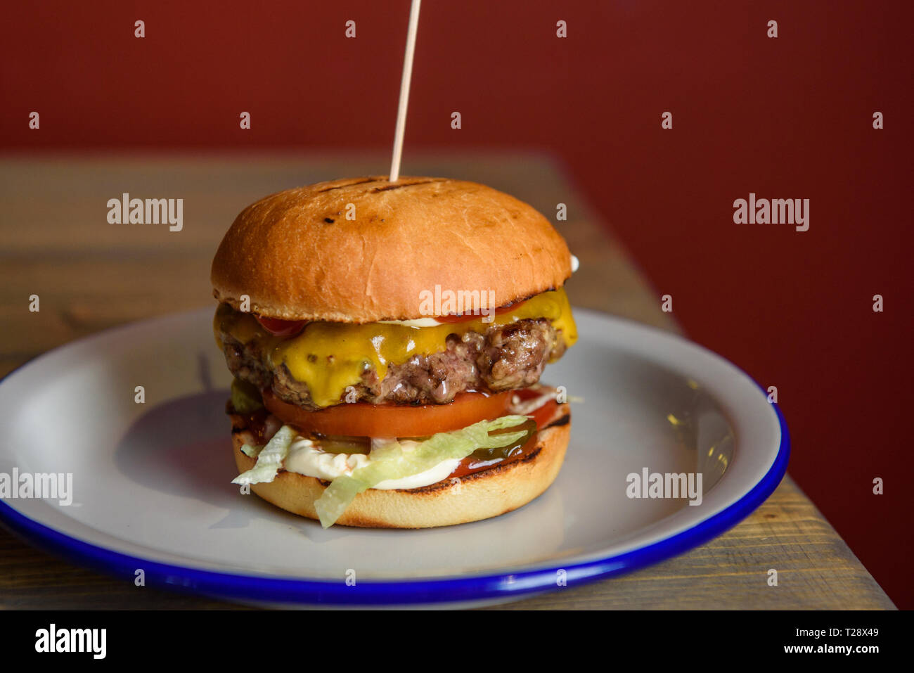 Beef burger on white plate ready to eat Stock Photo - Alamy
