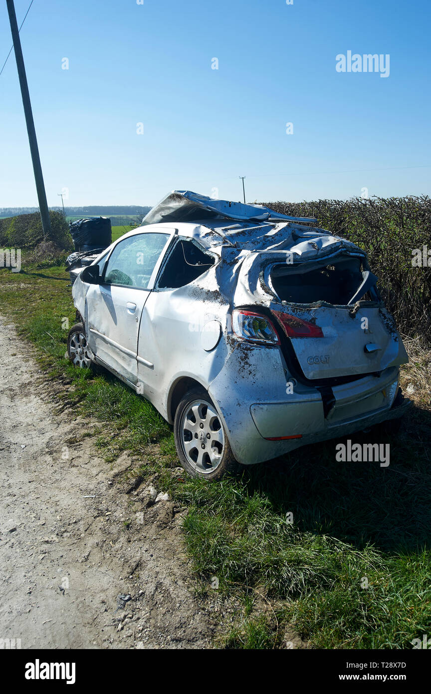 Mitsubishi Colt car wreck at the side of a quiet country road Stock ...