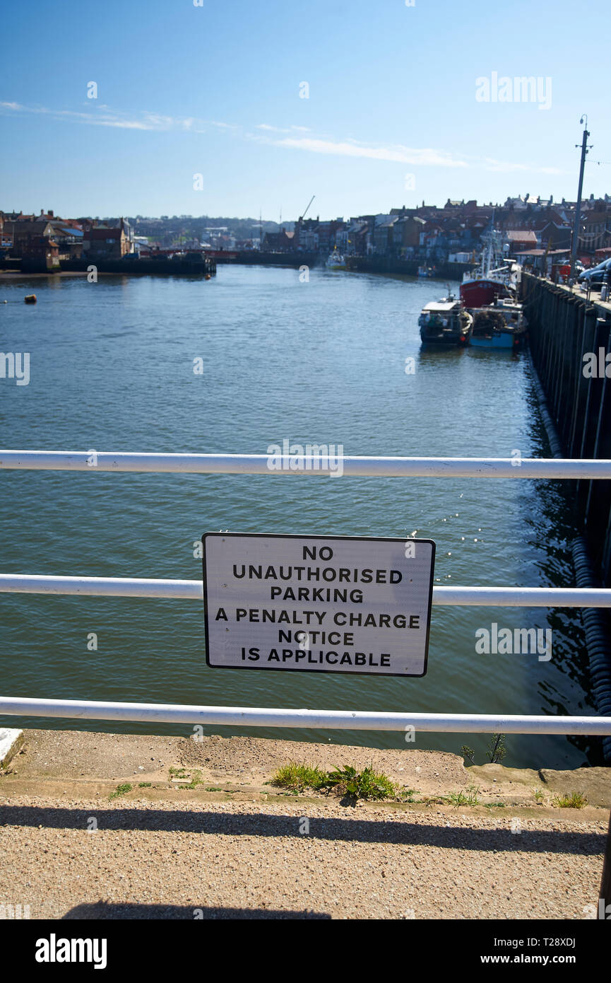 Whitby Harbor with a funny parking sign, Whitby North Yorkshire ...