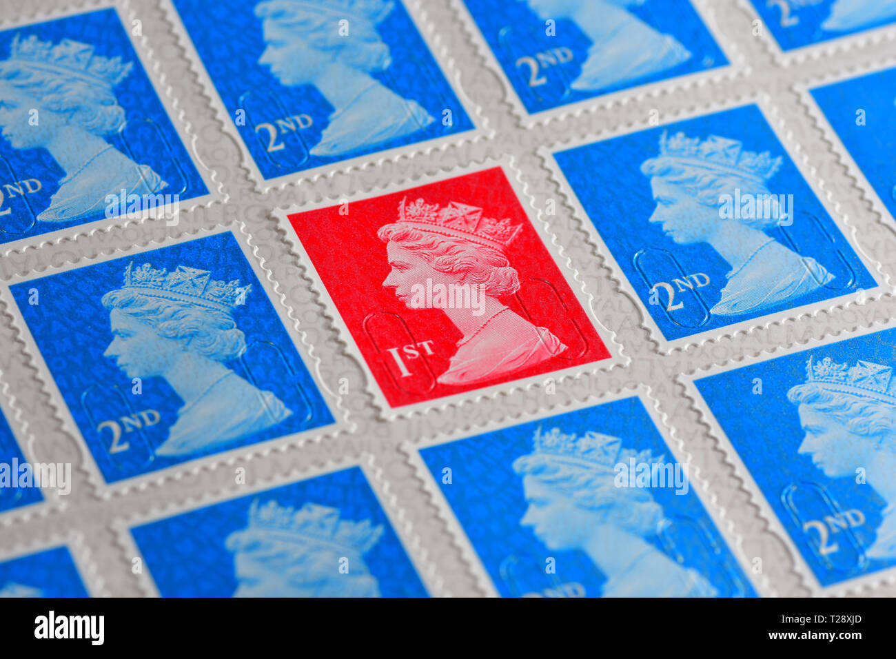 One red British 1st Class Stamp with blue 2nd class stamps Stock Photo ...
