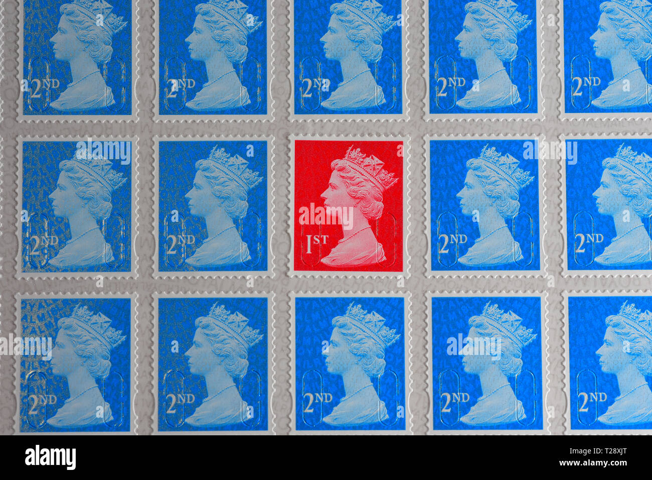 One red British 1st Class Stamp with blue 2nd class stamps Stock Photo ...