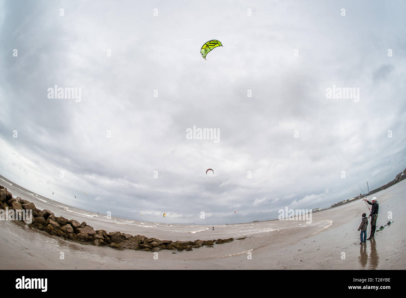 A man shows his son how to fly a power kite Stock Photo - Alamy