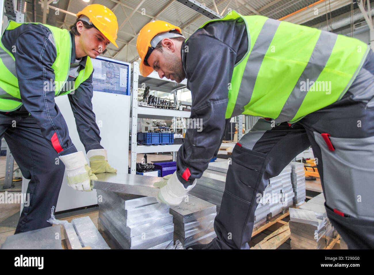 Workers taking aluminium billet at CNC machine shop Stock Photo - Alamy