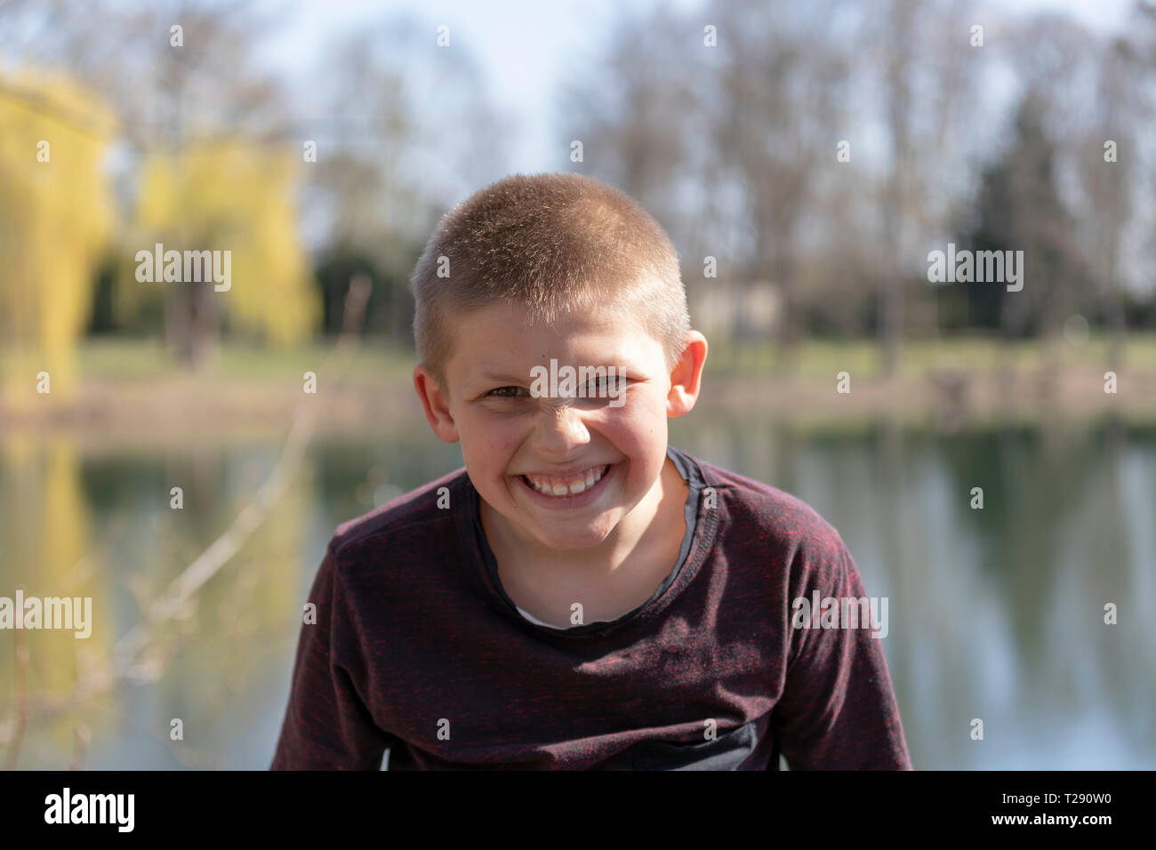 Emotional portrait of a kind and happy little boy looking with a smile ...