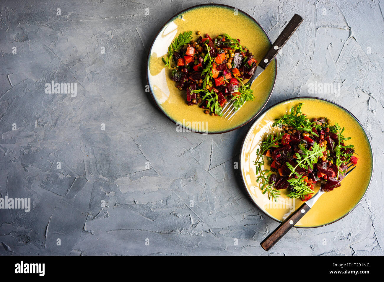 Vegetable salad with beetroot and rocket herb on rustic background with ...