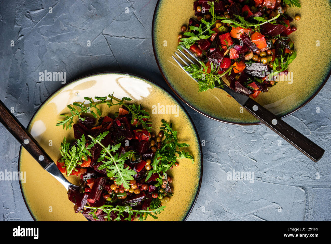 Vegetable salad with beetroot and rocket herb on rustic background with ...