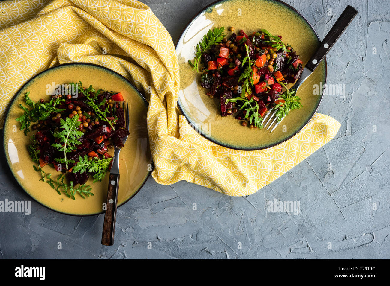 Vegetable salad with beetroot and rocket herb on rustic background with ...