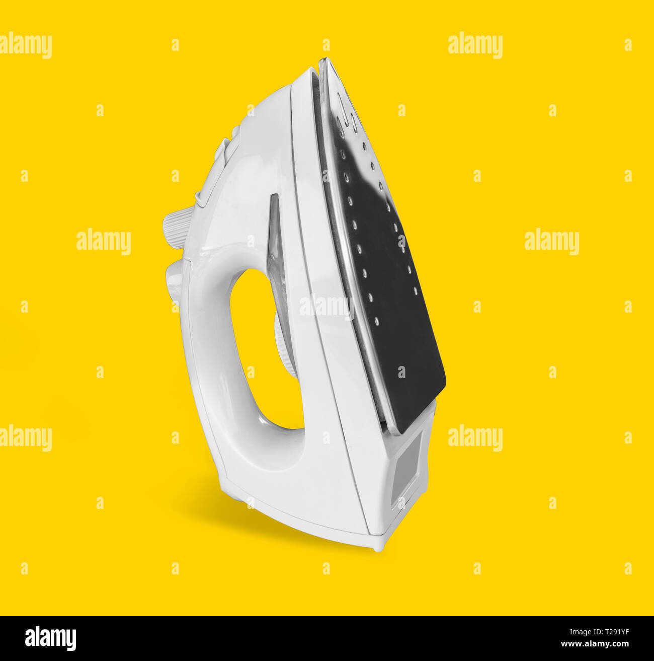 Iron isolated on yellow background with clipping path Stock Photo - Alamy