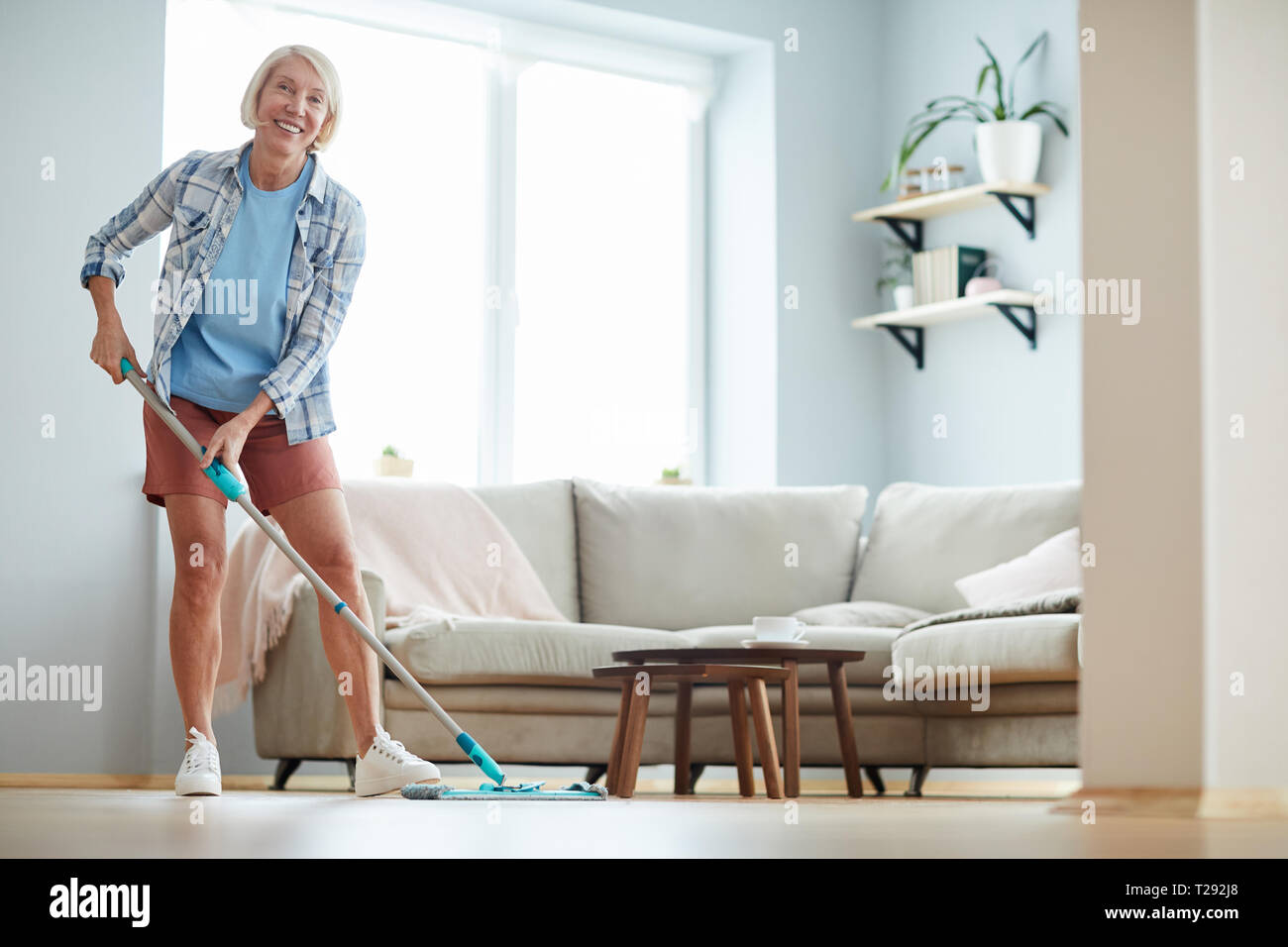 Mature woman cleaning house hi-res stock photography and images - Alamy