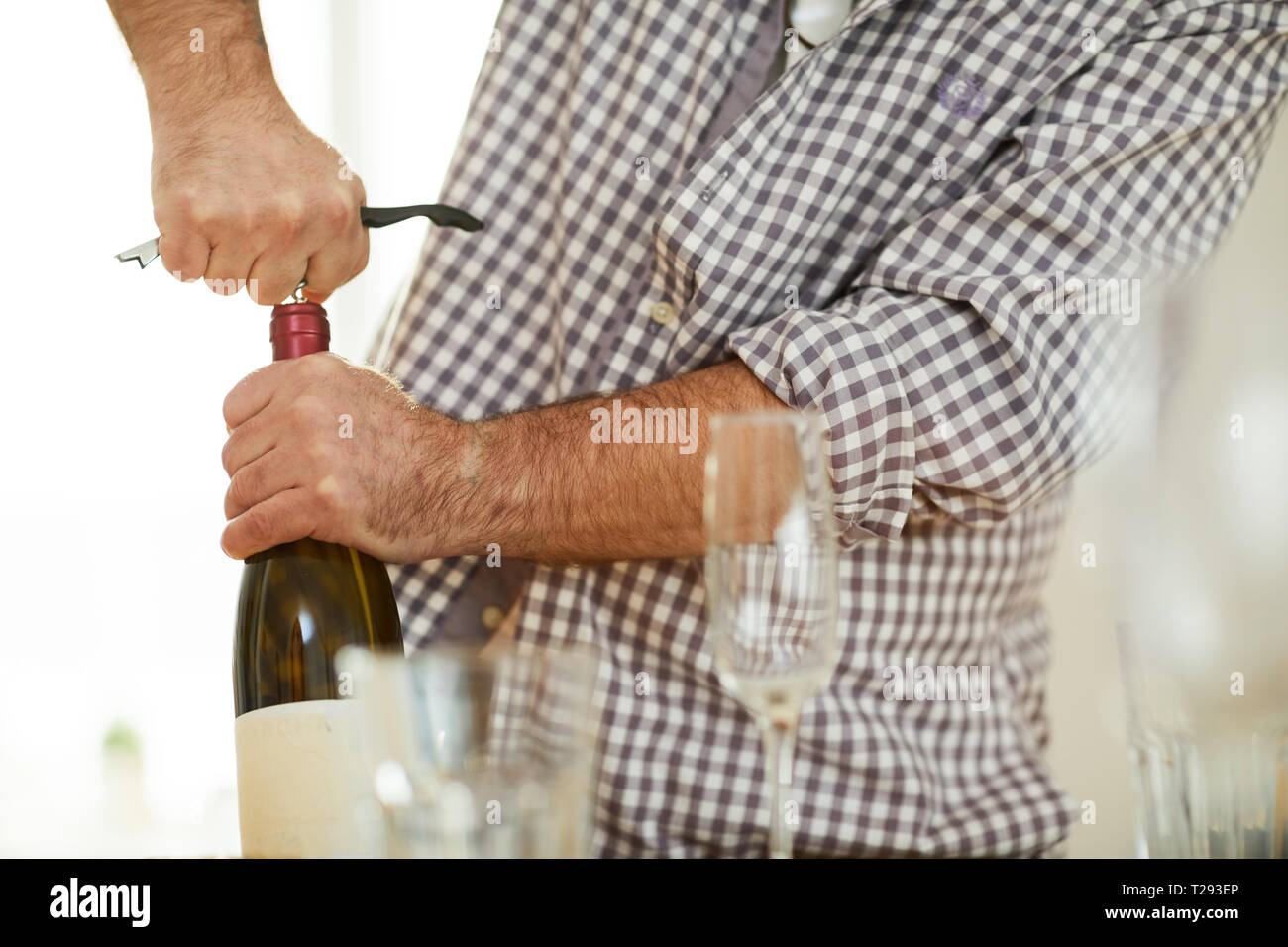 Drawing cork from wine bottle Stock Photo - Alamy