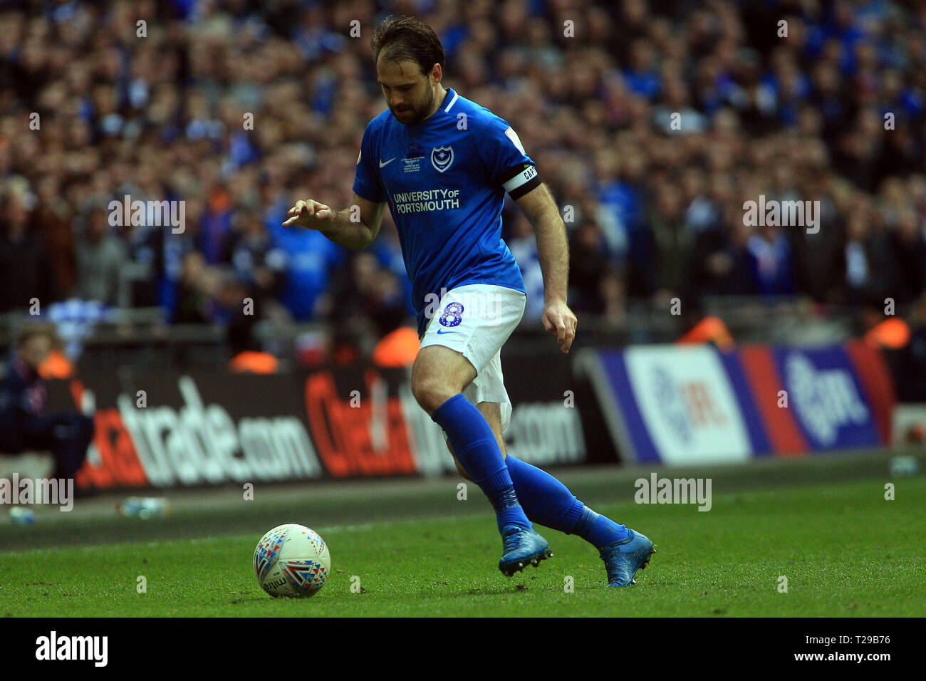 London, UK. 31st Mar, 2019. Brett Pitman of Portsmouth in action ...
