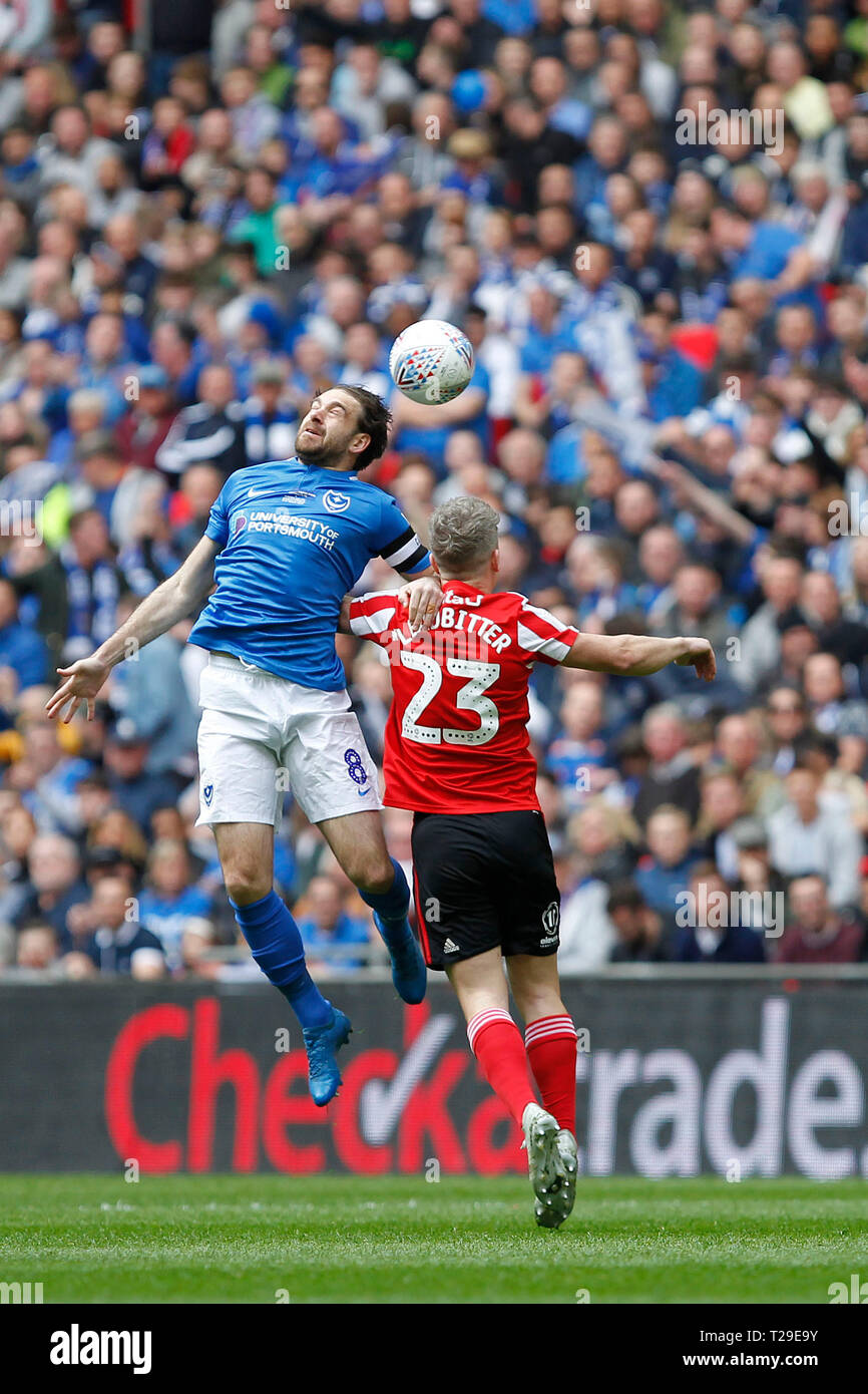 Brett Pitman of Portsmouth wins the header during the Checkatrade ...