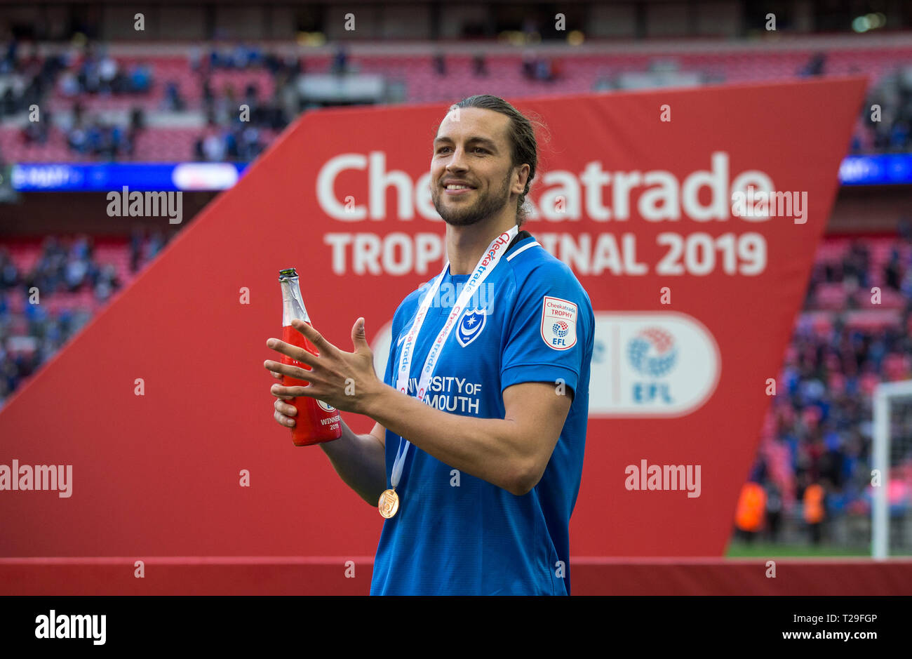 Christian Burgess of Portsmouth celebrates after the team win the ...