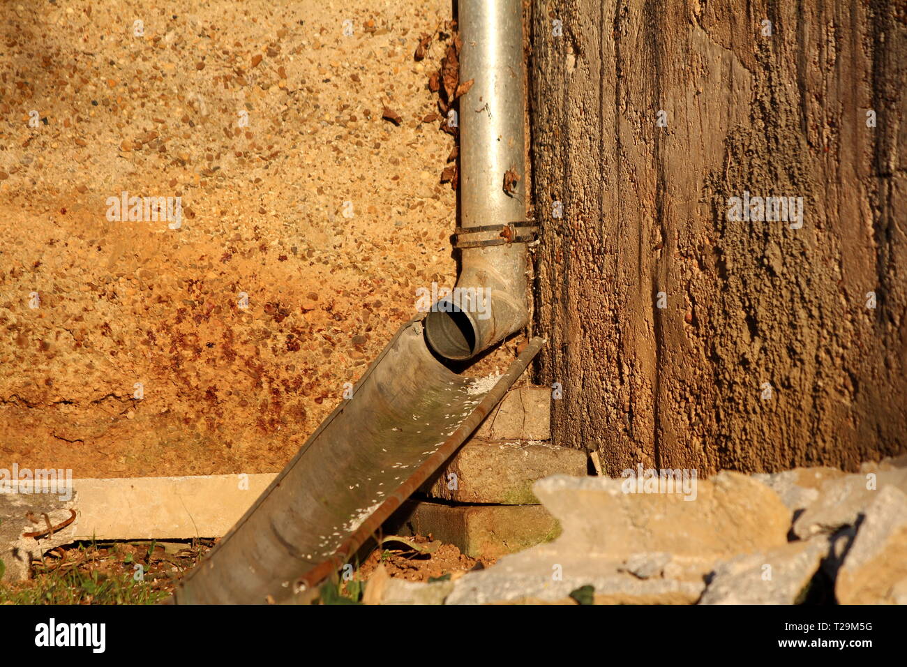 Family house grey metal gutter pipe mounted on side of the wall and ...