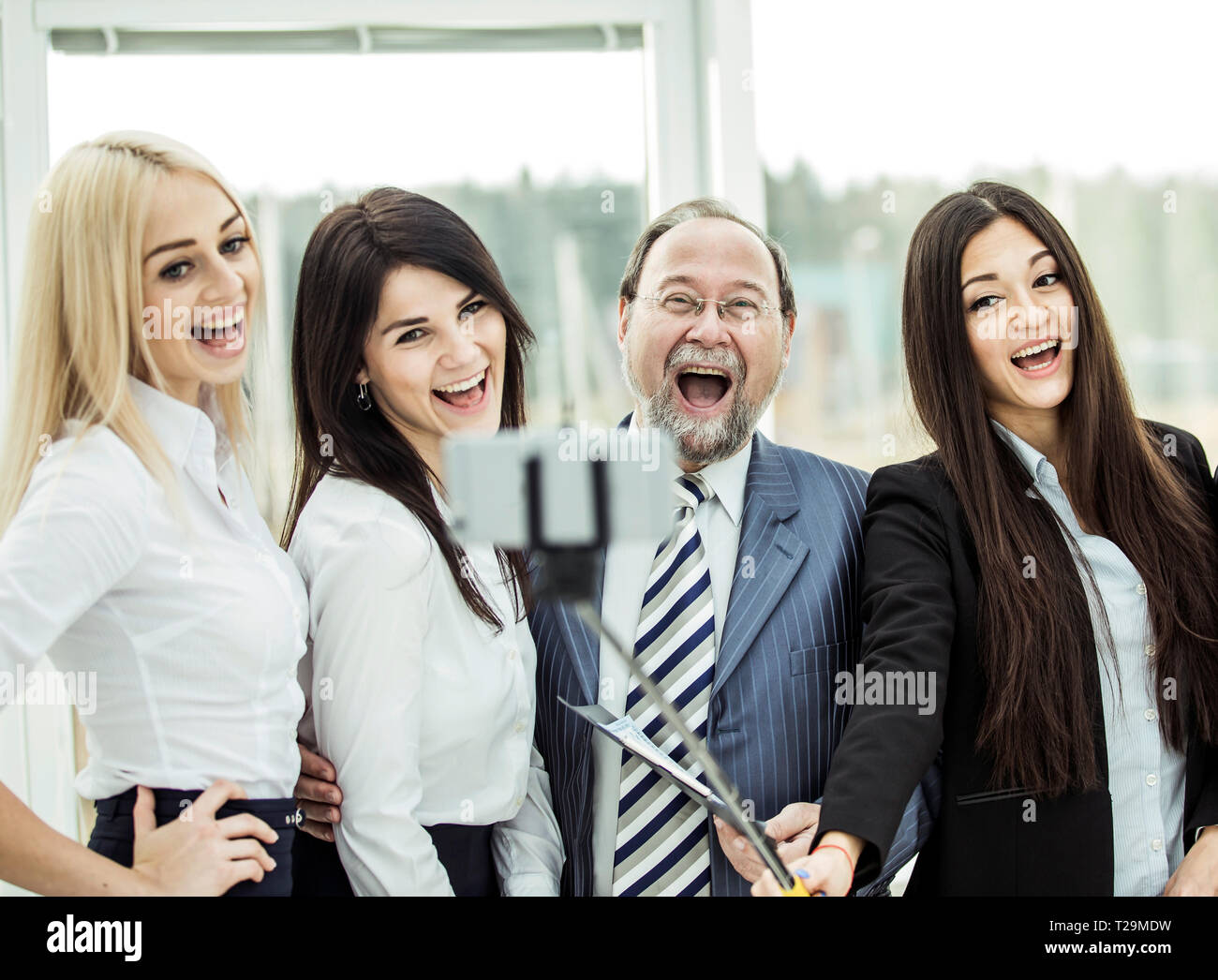 concept of success - boss and triumphant business team. on the ...