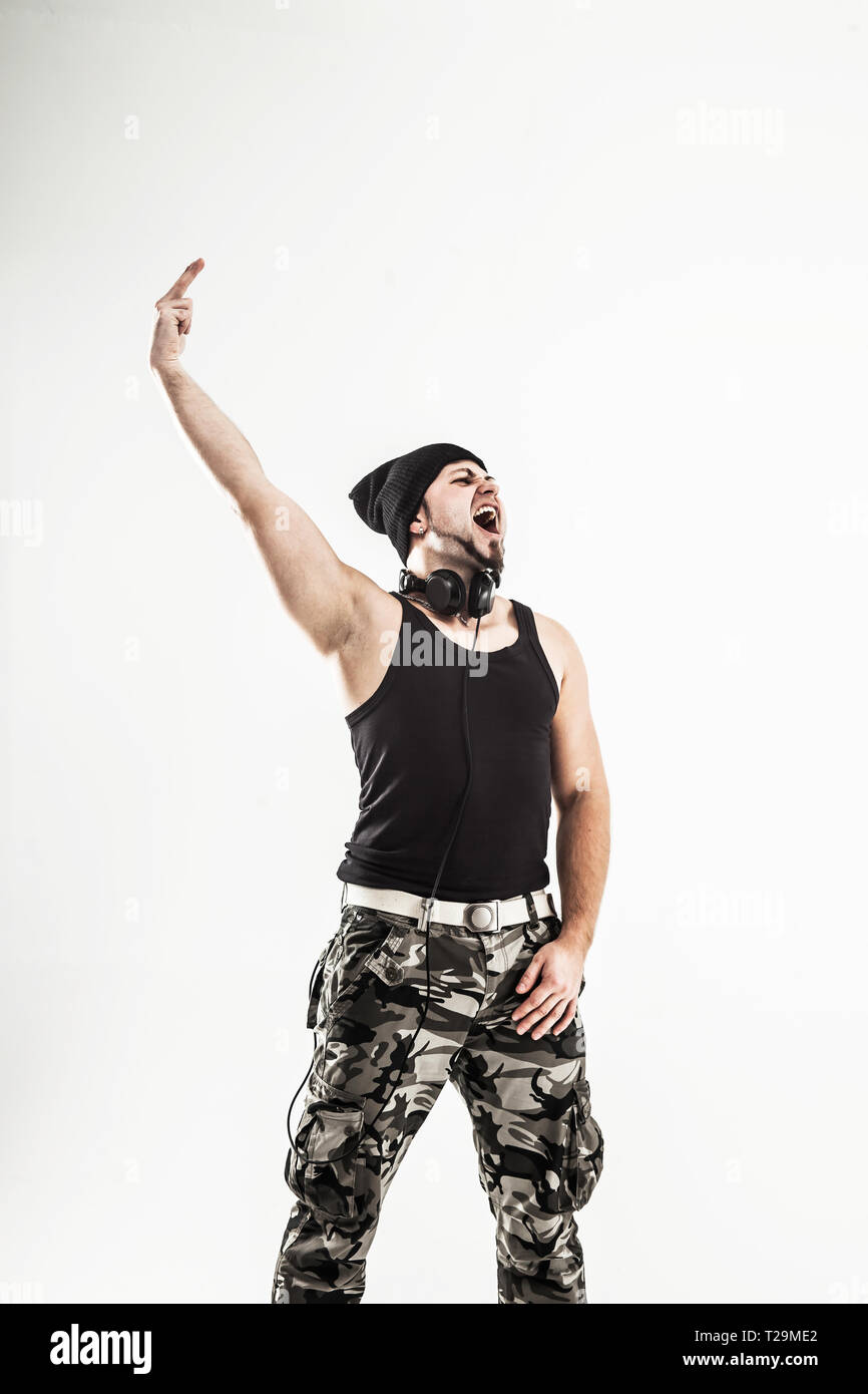 emotional and charismatic DJ - rapper with headphones on a light Stock ...