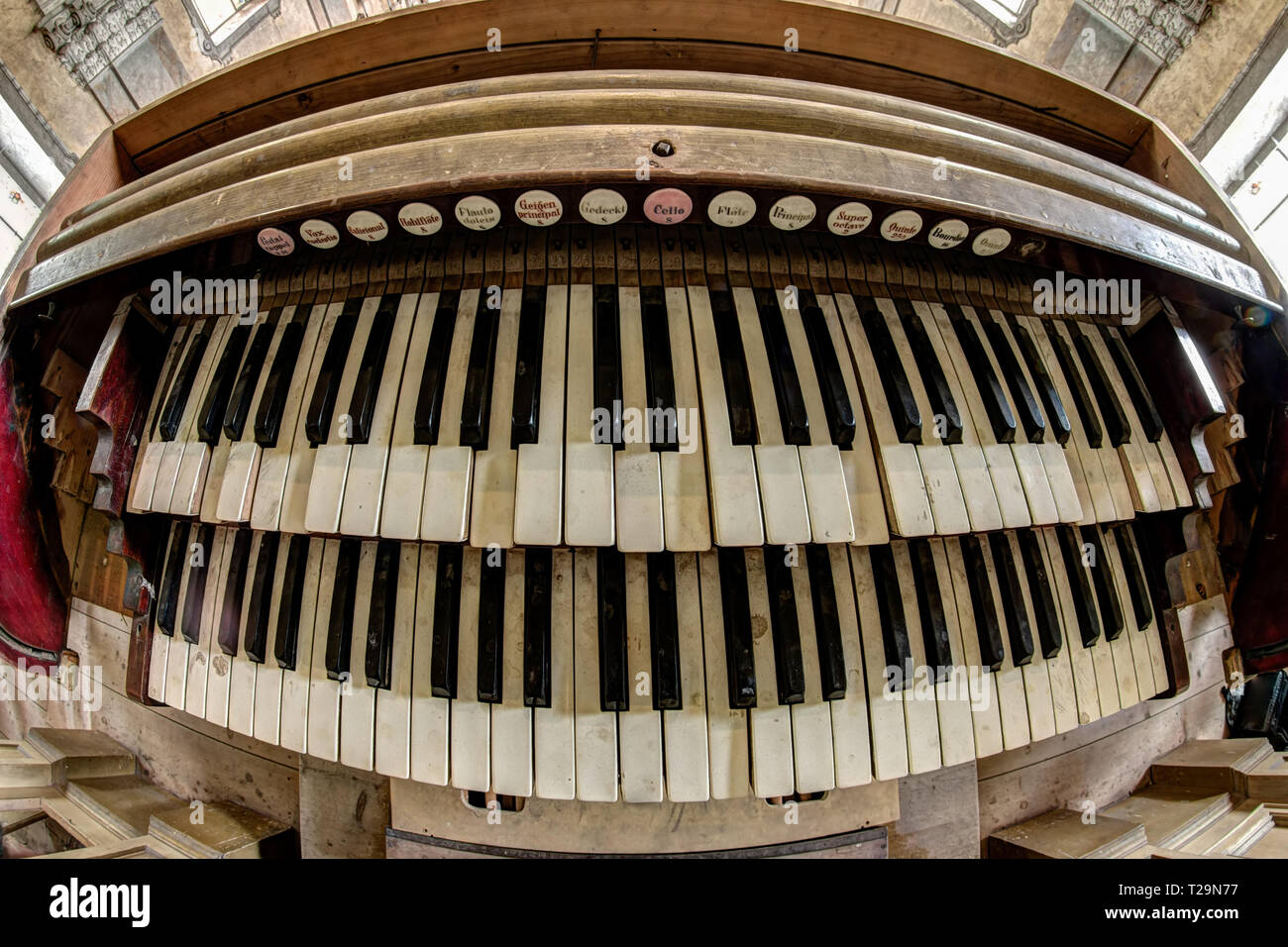 Old and broken church organ - detail of the keyboard - fish eye lens ...