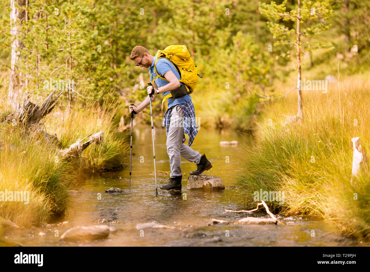 Young man crosses river hi-res stock photography and images - Alamy