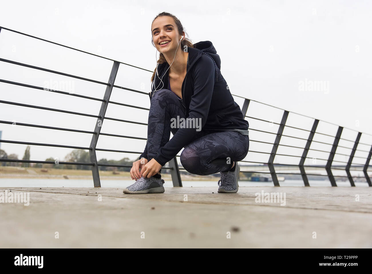 Woman tying shoe hi-res stock photography and images - Alamy