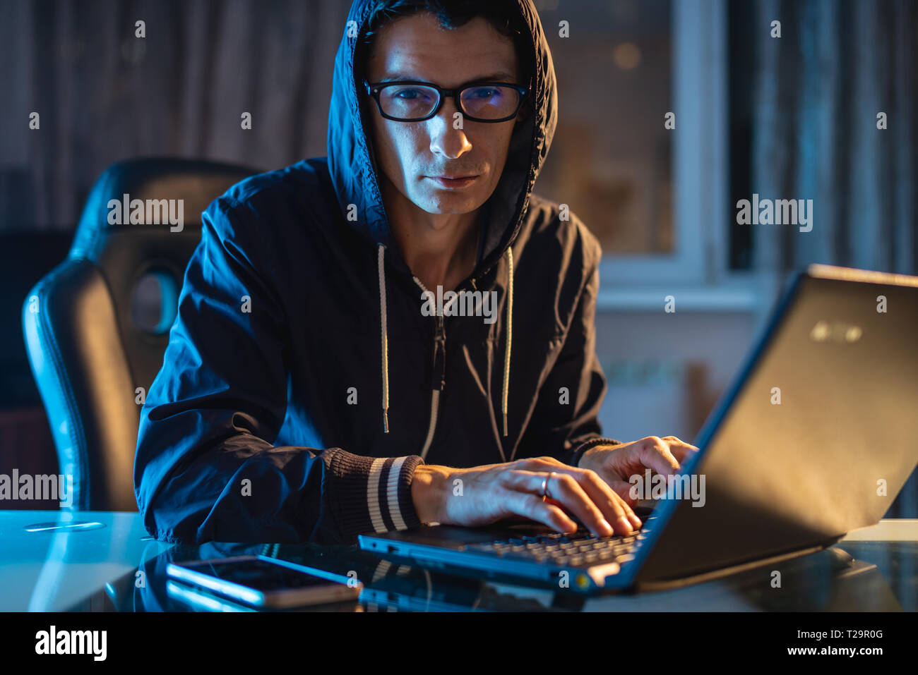 Man In The Hood Looking In The Camera Hacker Attacks And Stealing Access Databases With