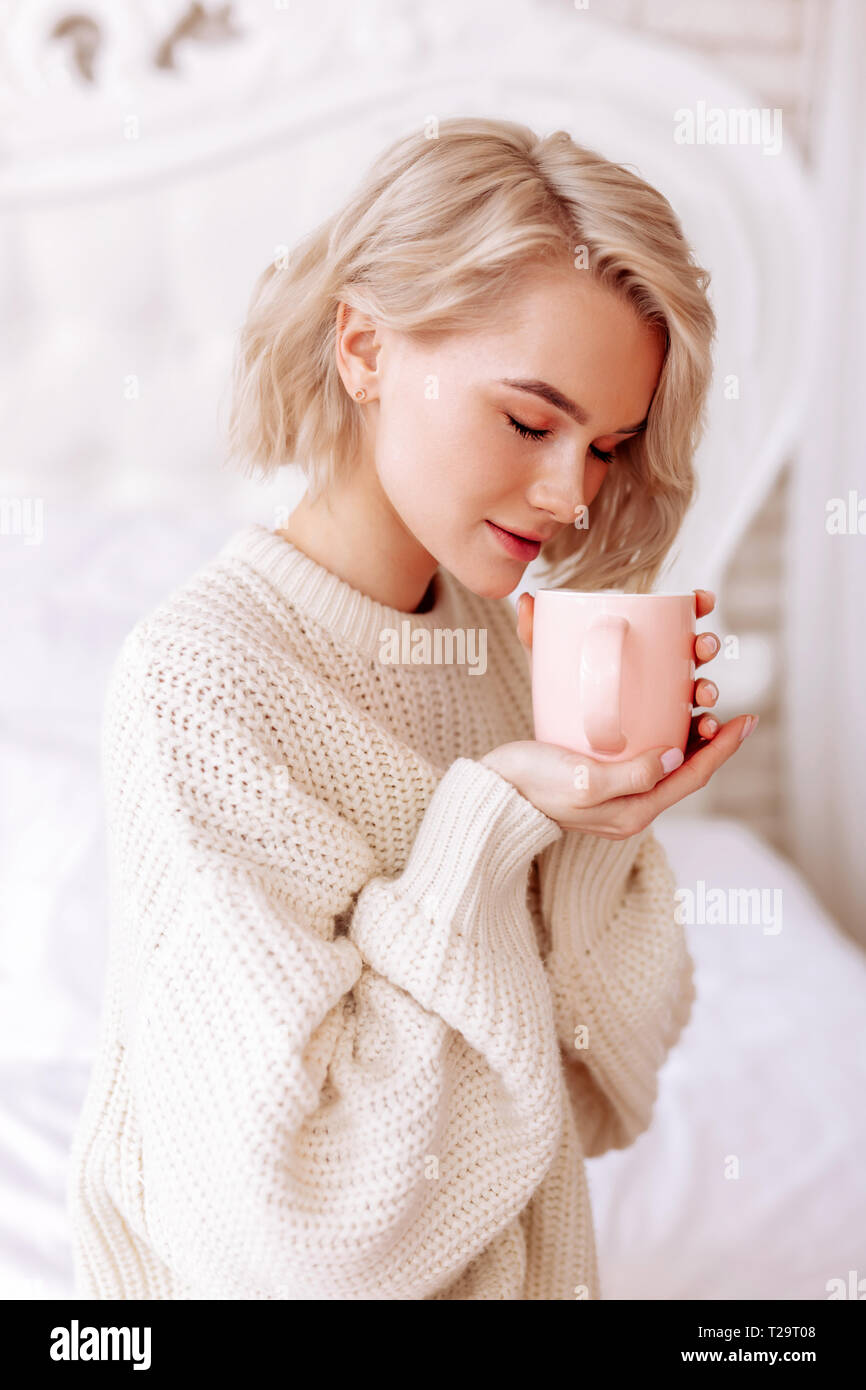 Young appealing woman feeling joyful smelling morning coffee Stock ...