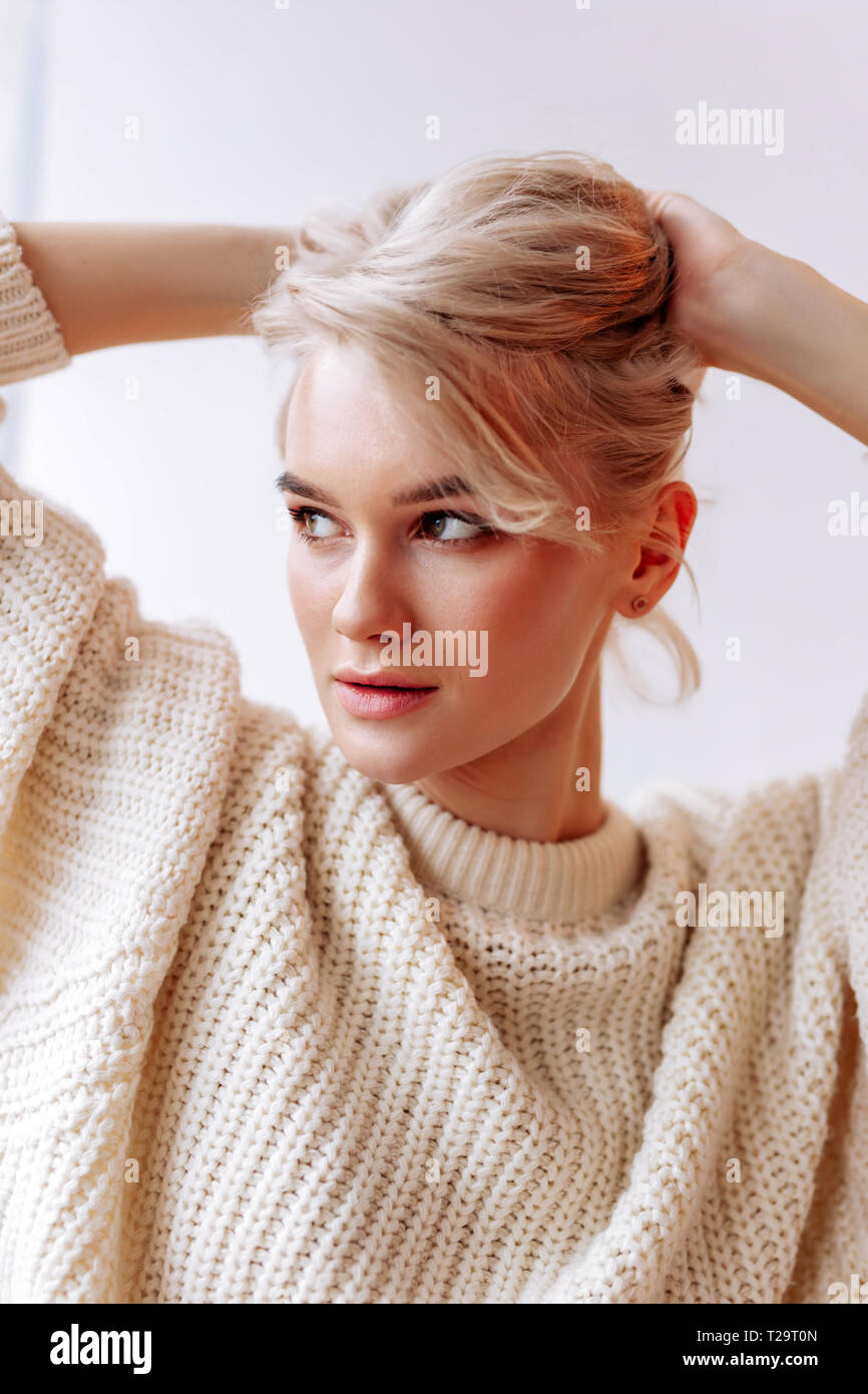 Young woman with beautiful face looking into window at home Stock Photo ...