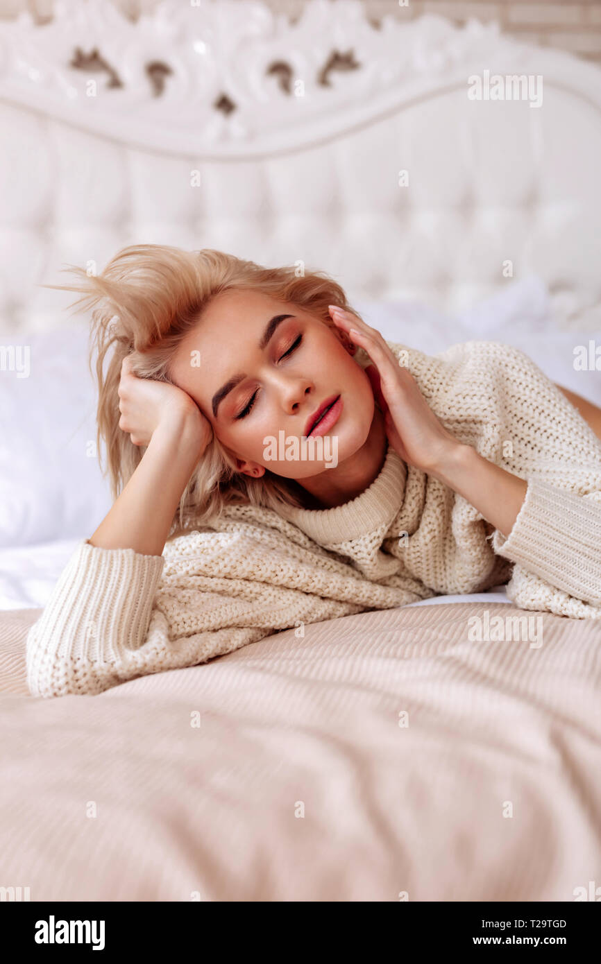 Model closing her eyes while posing for magazine cover Stock Photo - Alamy