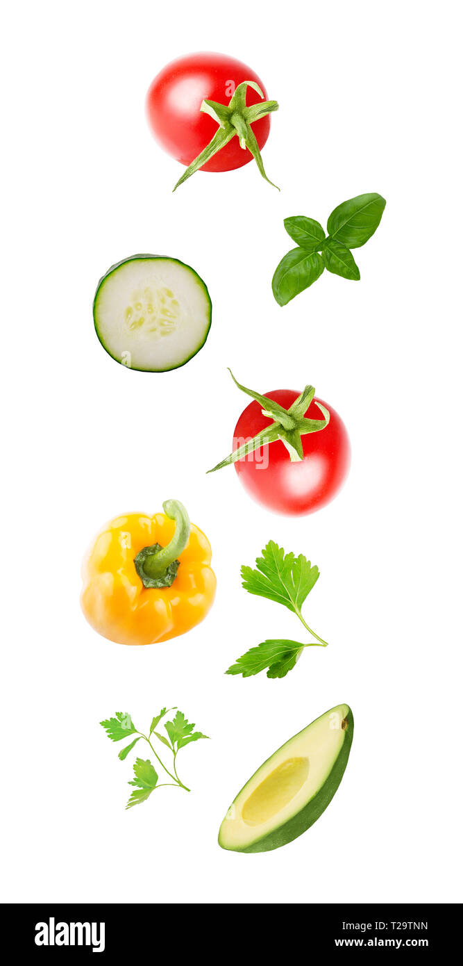 Flying vegetable concept. Fresh organic tomato, cucumber, avocado ...