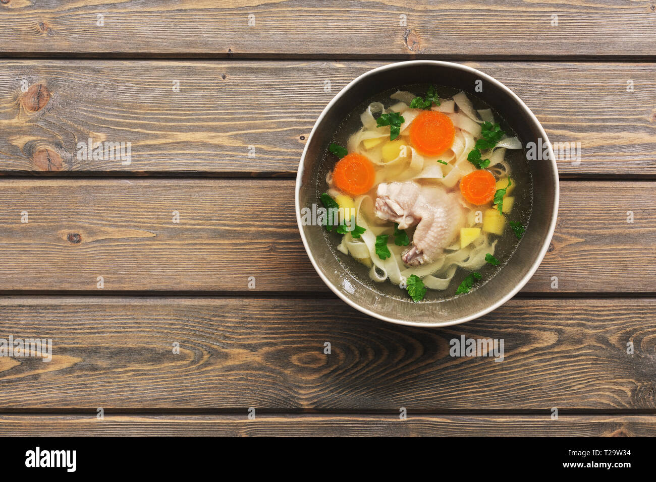 Chicken noodle soup on a wooden plank table. Top view, copy space Stock ...