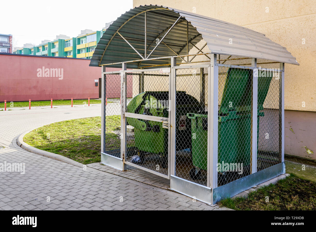 waste containers are placed in a metal wire mesh shed with a code key ...