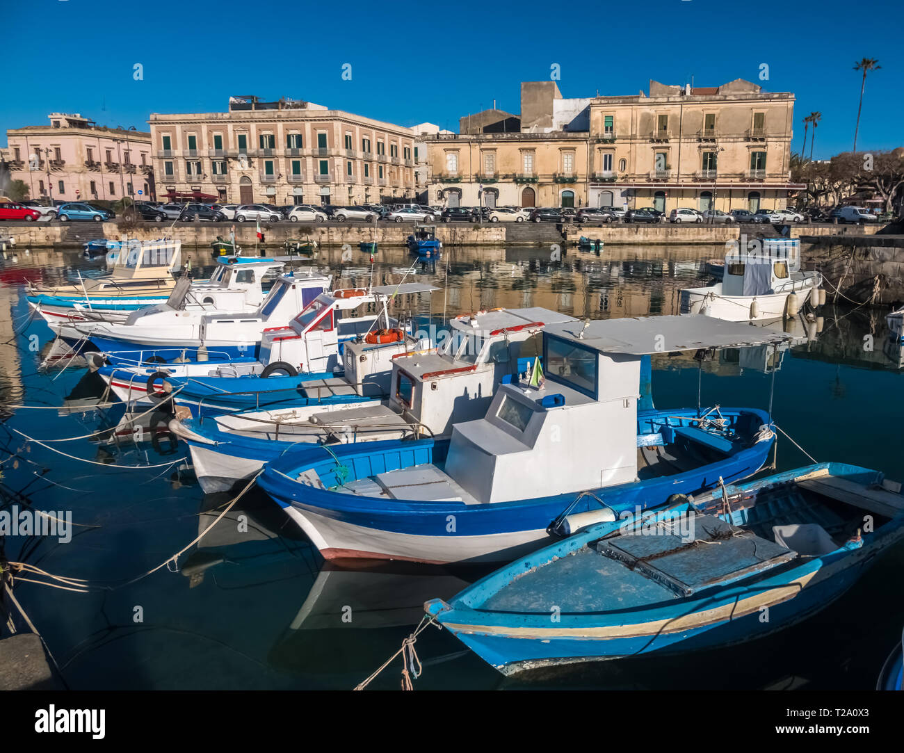 A colorful variety of boats and ships fill the docks of the harbors of ...