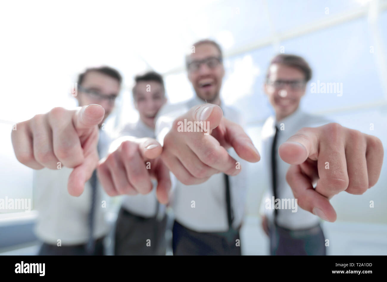 business background.happy employees pointing at you Stock Photo - Alamy